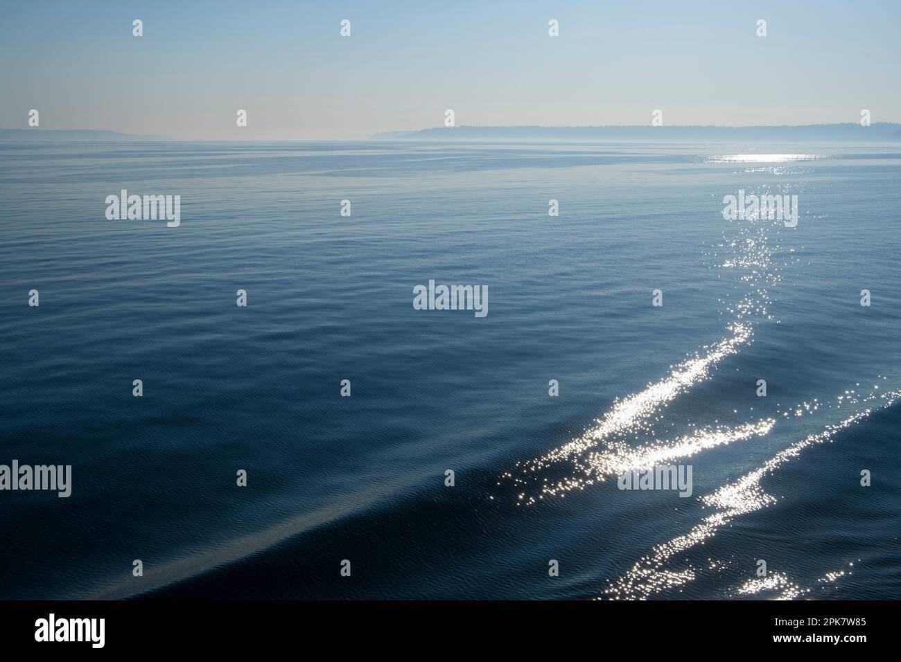 A wake from ferry boat, ripples and reflections on the water Stock ...
