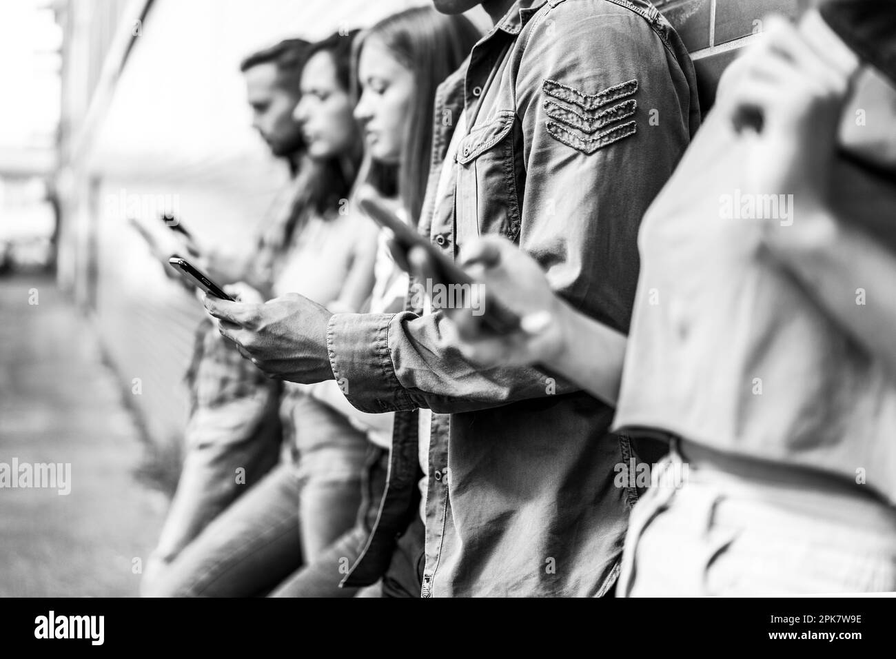 Bored friends group using smartphone sitting at university college ...