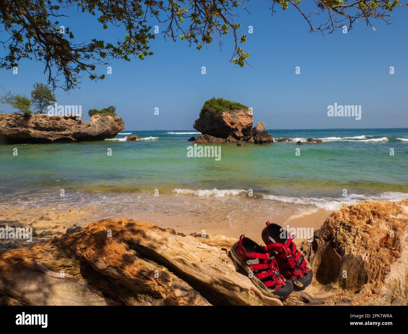 Dar es Salaam, Tanzania - January 2021: Red shoes on the hidden sandy ...