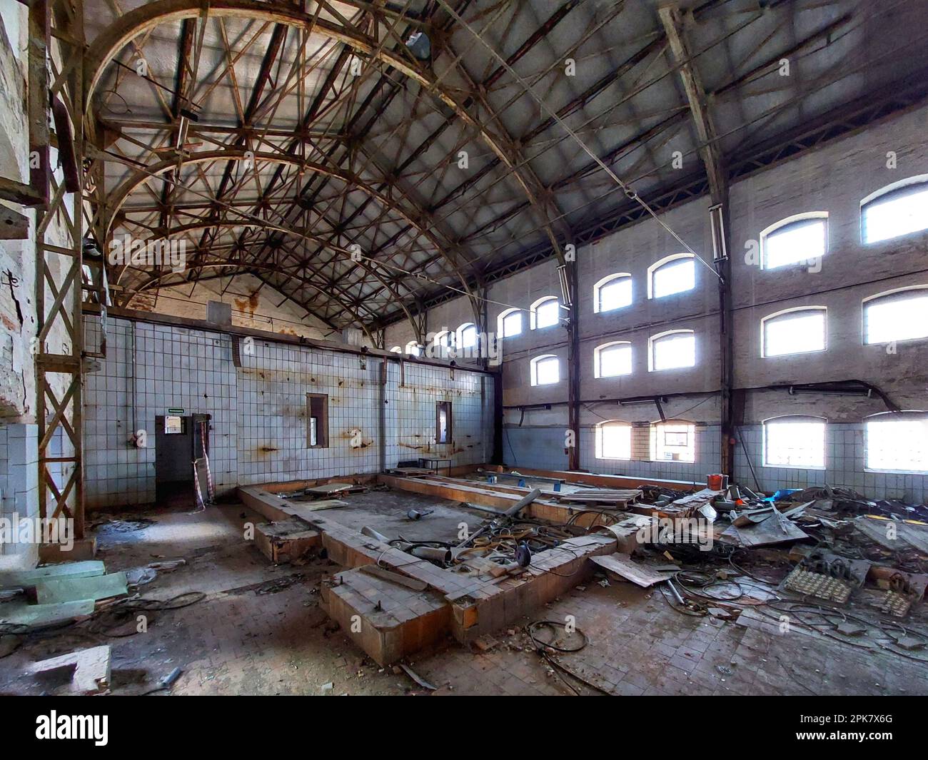 Ruined factory hall with debris and many windows Stock Photo - Alamy