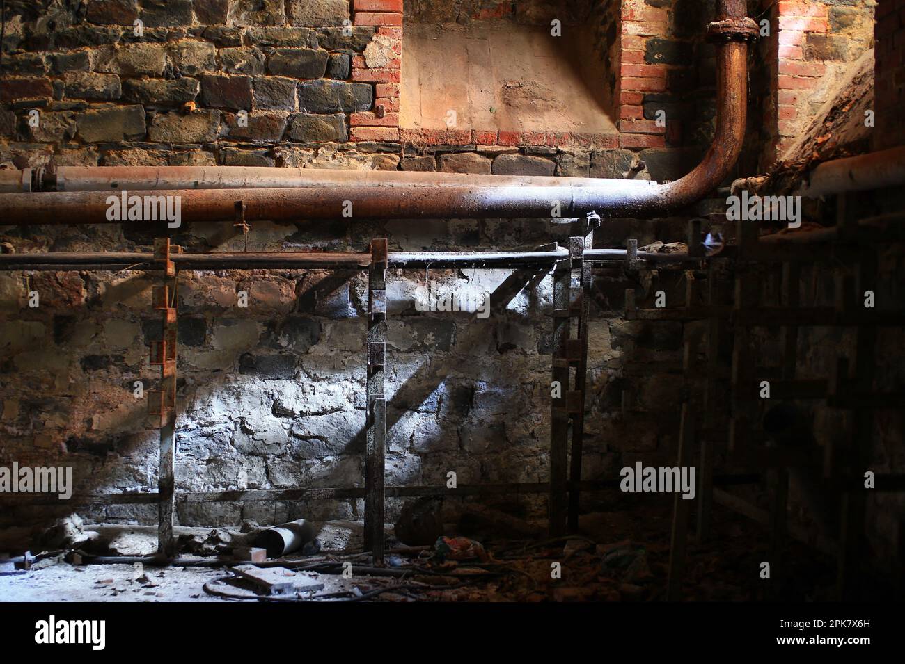 Rusty pipes in dark abandoned industrial basement Stock Photo - Alamy