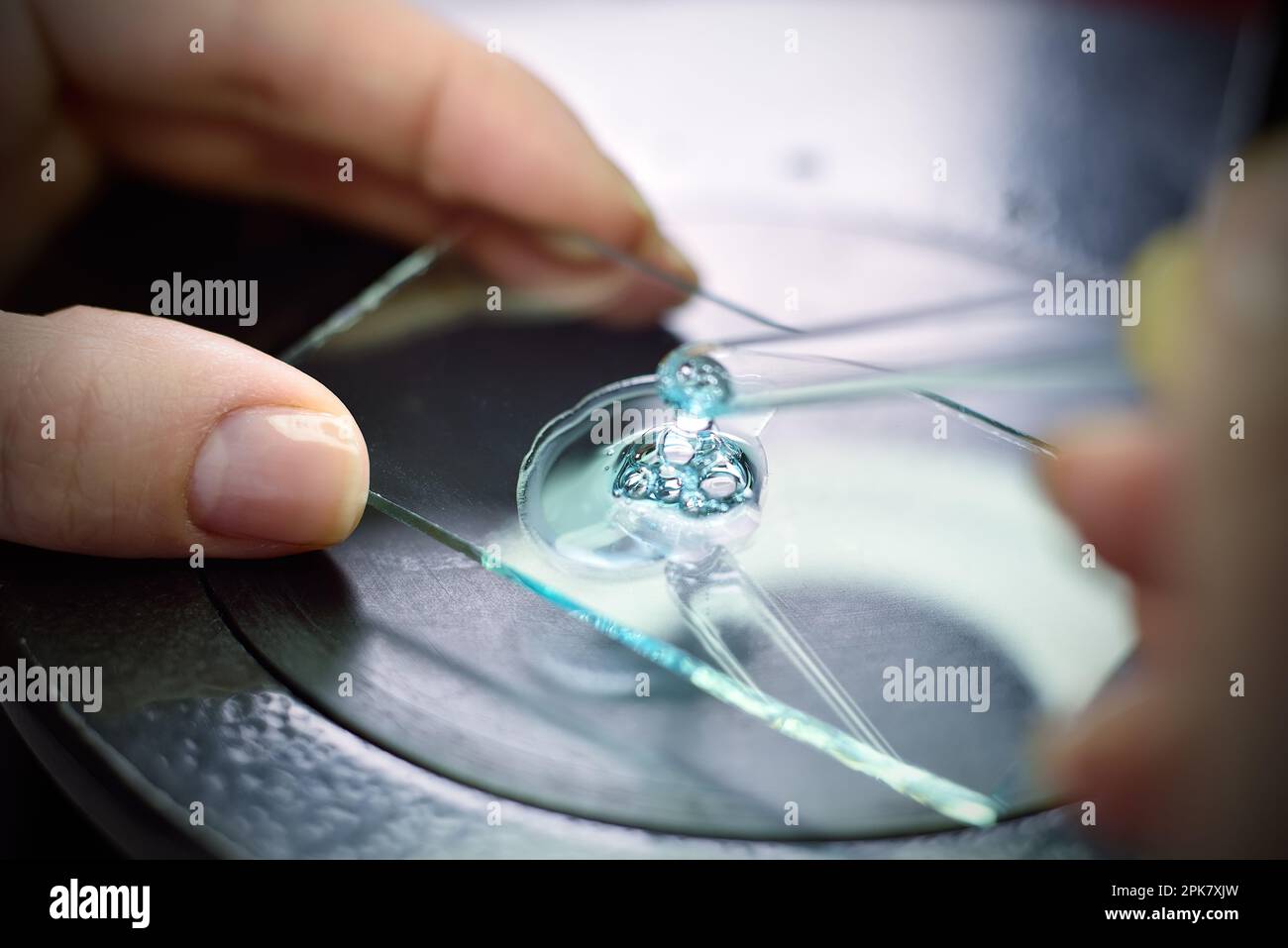pipette takes a sample of blue liquid, extra close up Stock Photo - Alamy
