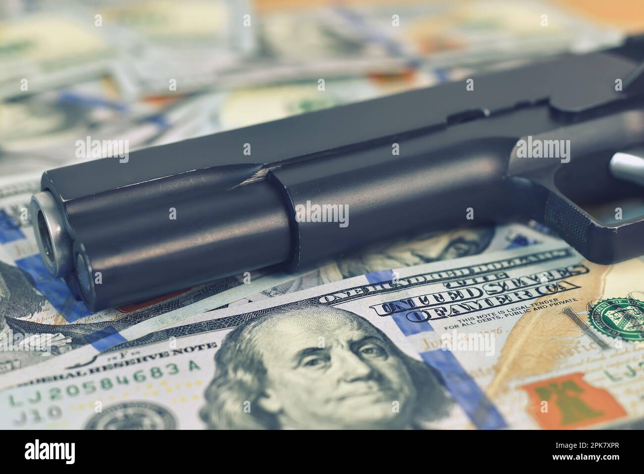 black gun he is lying on dollar bills Stock Photo - Alamy