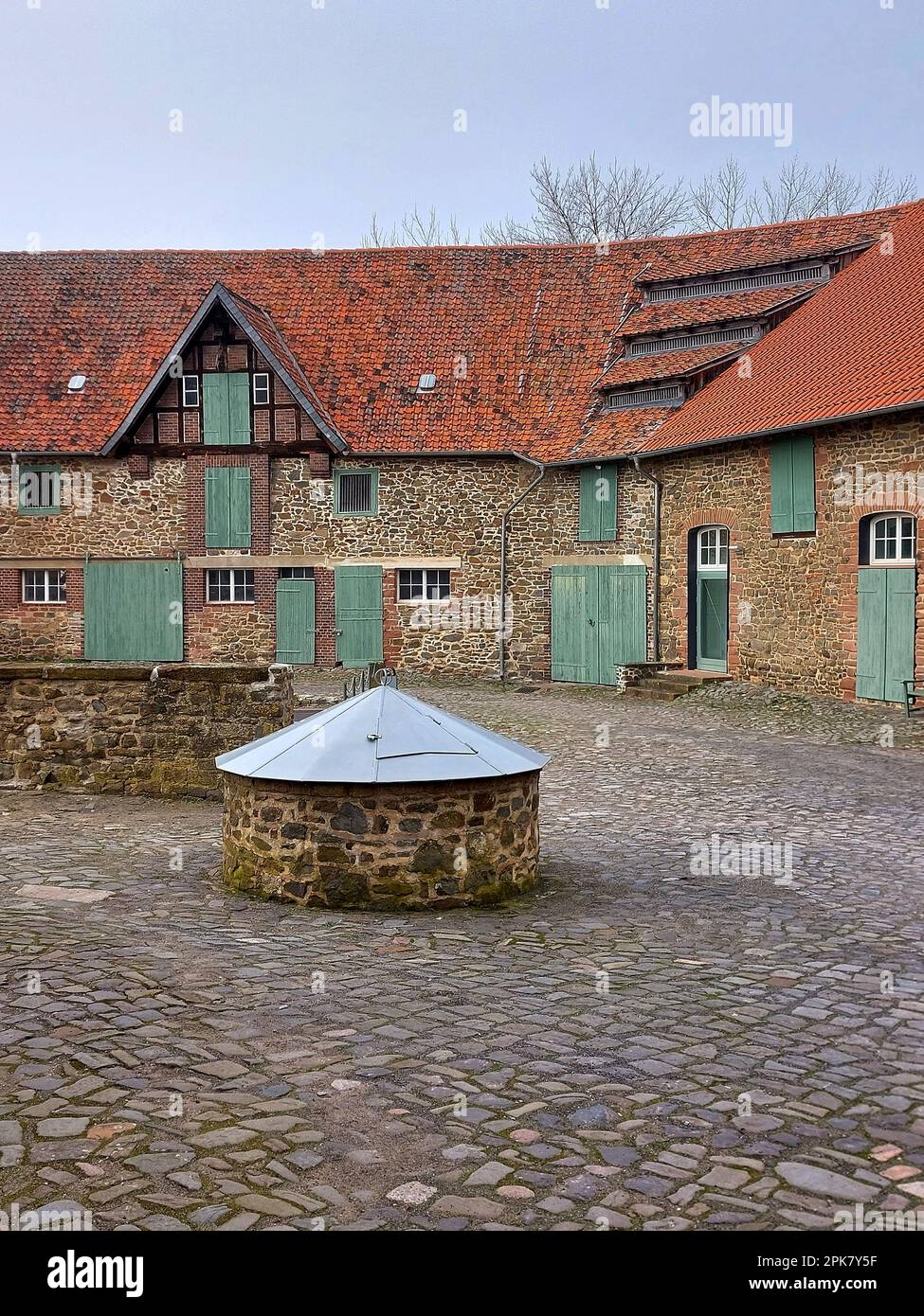 Authentic medieval barns and well in a historic German castle Stock ...