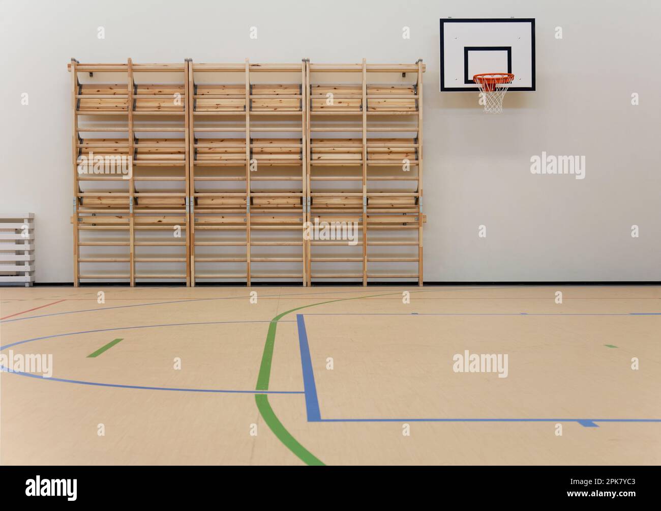 Indoor basketball court at a school. Wooden floor and marked court, a ...
