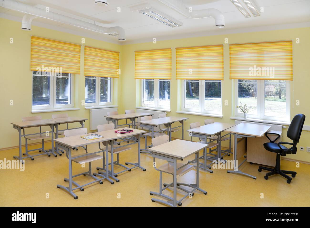 A school classroom with desks and chairs and yellow window blinds Stock ...