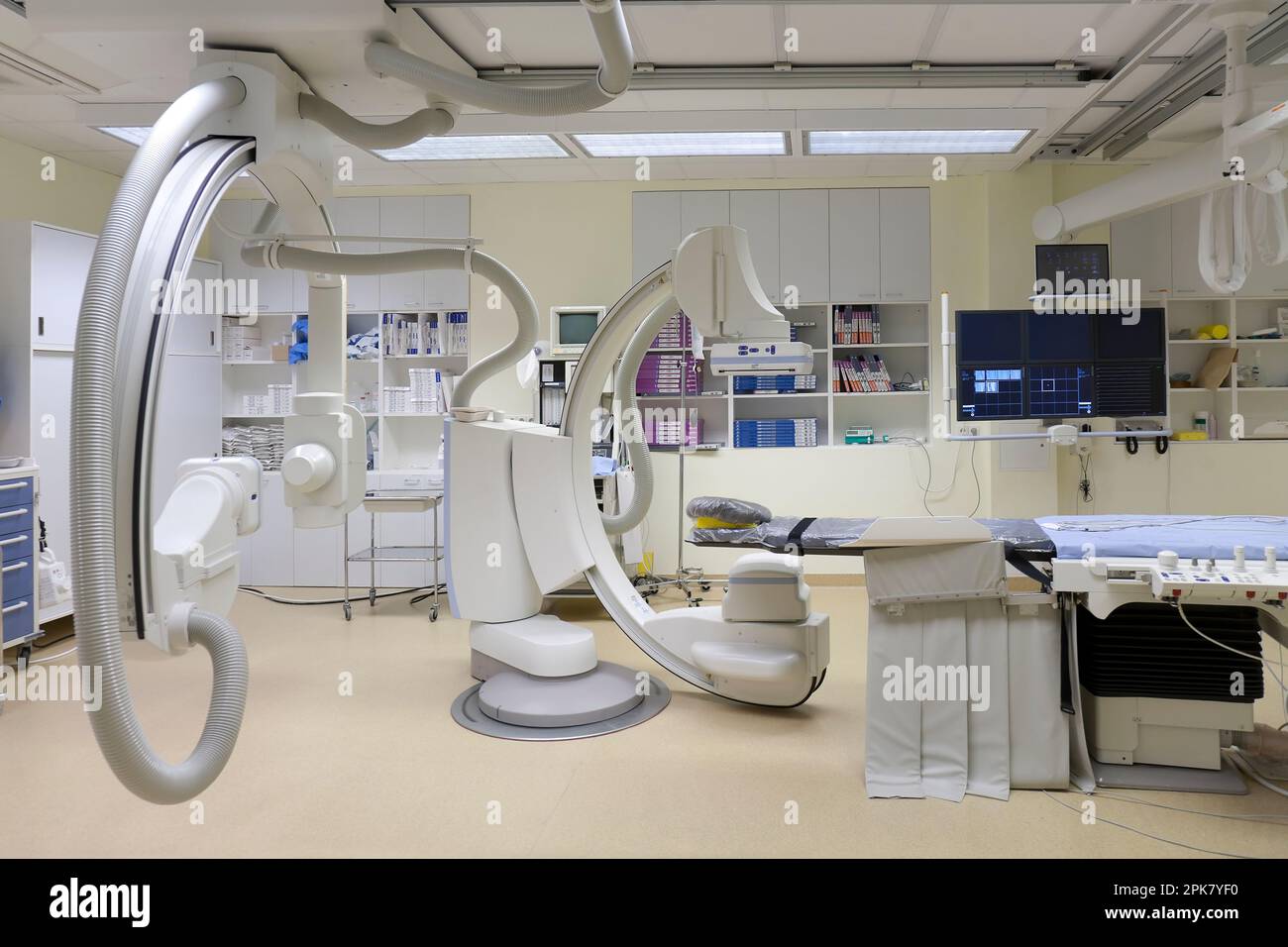 A modern hospital room, a large portable mobile scanning machine with ...