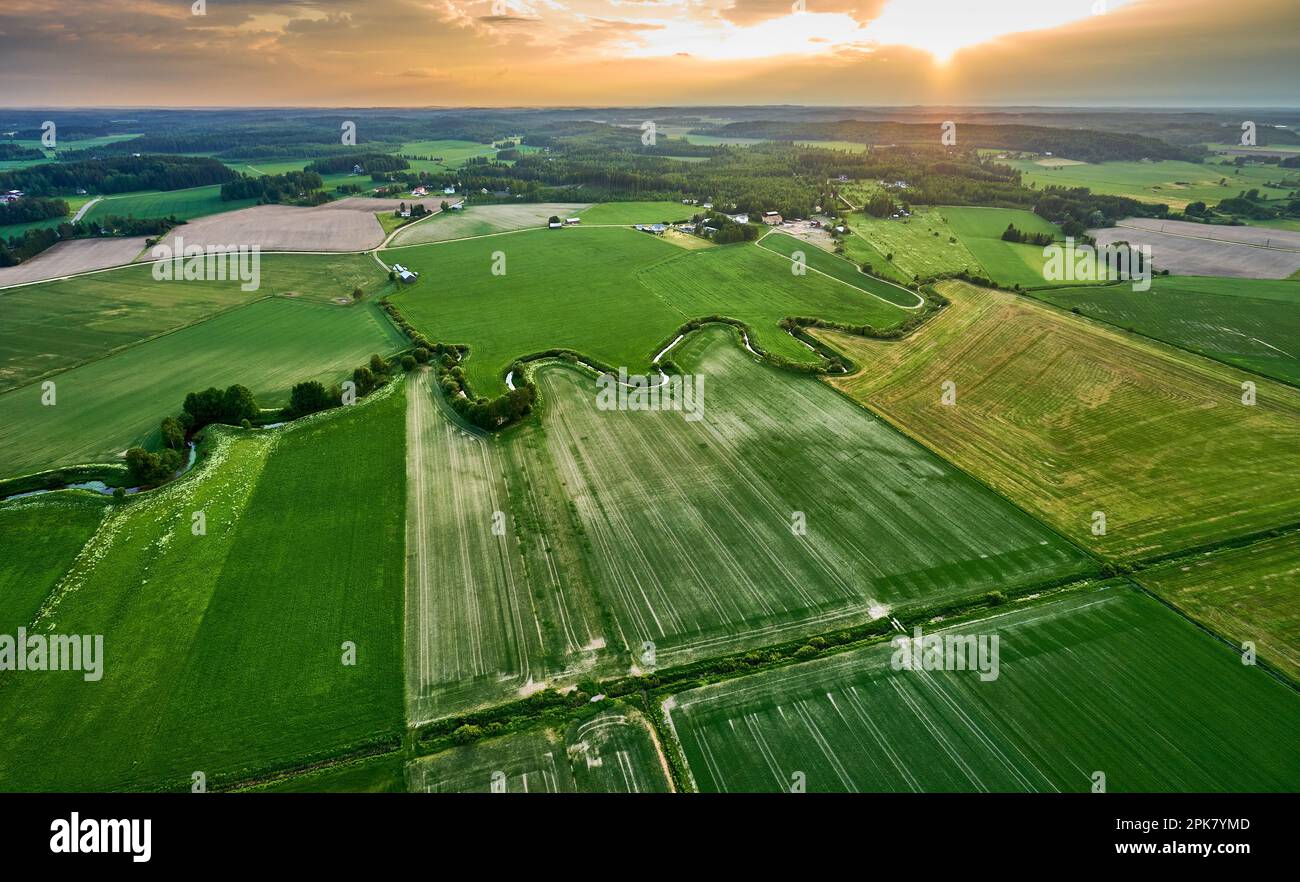 An aerial view of a rural landscape featuring a river snaking through ...