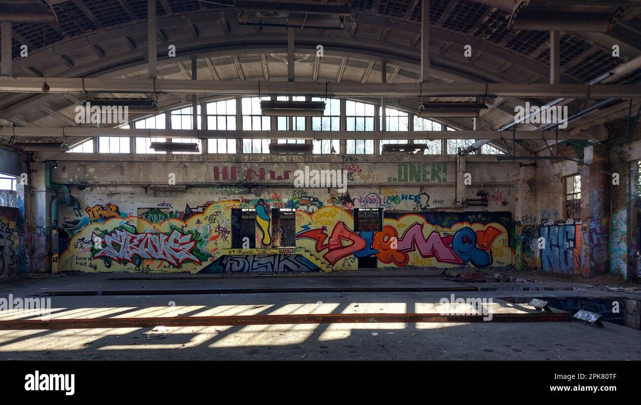 Interior of abandoned car repair workshop with sunlight falling in ...