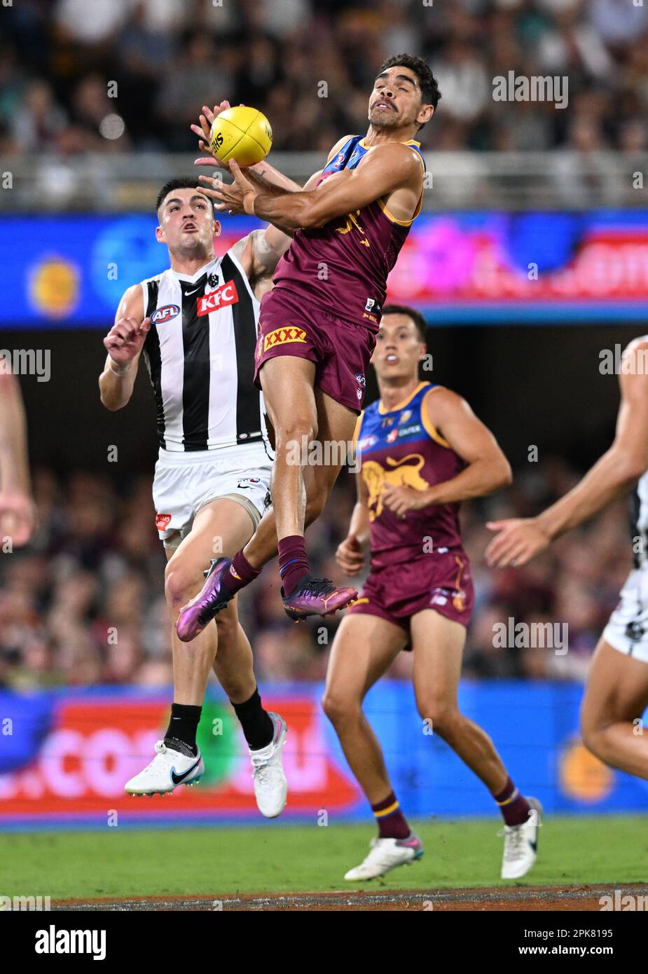 Charlie Cameron (centre) of the Lions takes a mark during the AFL Round ...