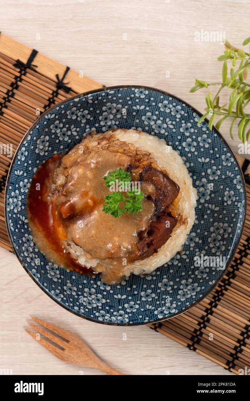 Migao, tube rice cake, rice pudding in a bowl topped with minced pork ...