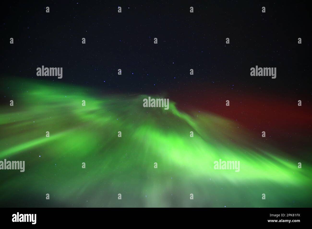 Red and green aurora formation on starry sky Stock Photo - Alamy