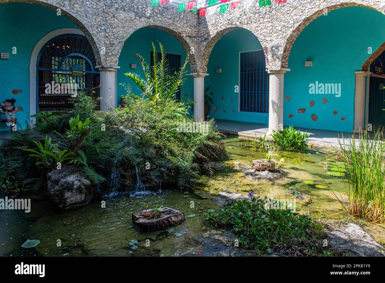 Fountain and lake of a patio terrace outside a Mexican hacienda with ...