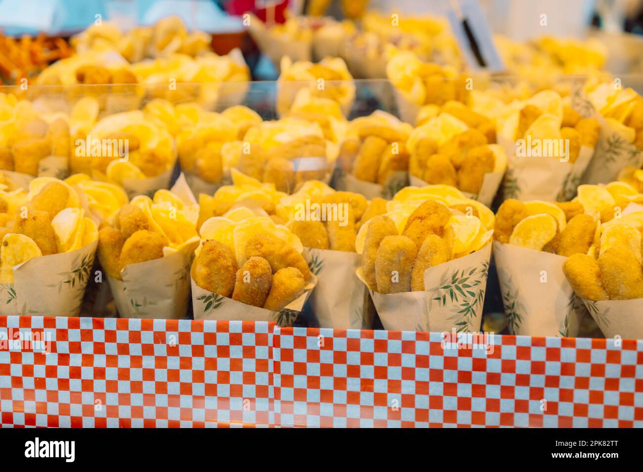 Spicy french fries snack wrapped in paper cone at the Boqueria market ...