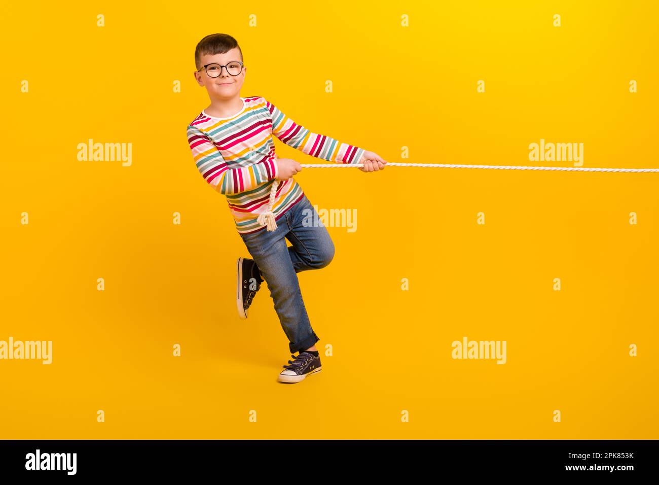 Full body photo of kid boy have weekend free time play active sport ...