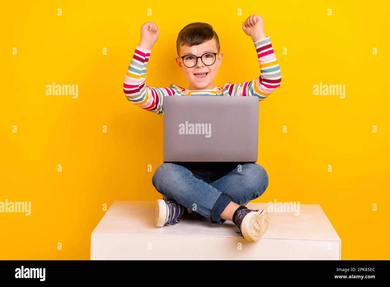 Photo of overjoyed cheerful boy wear stylish clothes sit platform ...