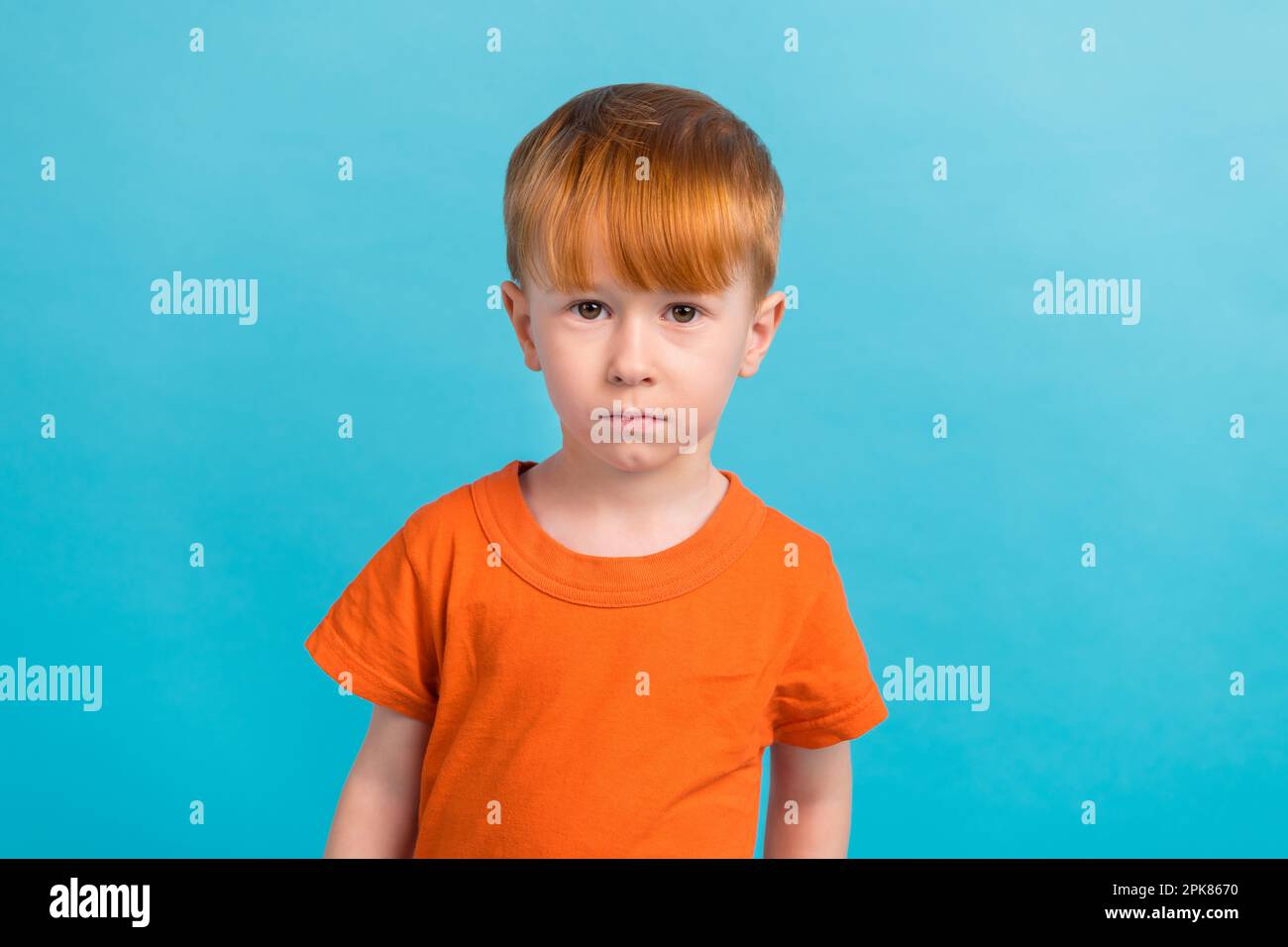 Portrait of charming cute little serious boy red hair nice haircut wear ...