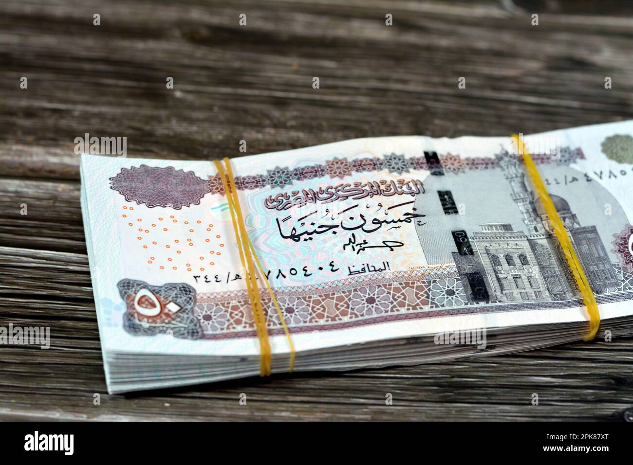 Egypt money stack of pounds isolated on wood background, pile of 50 EGP ...