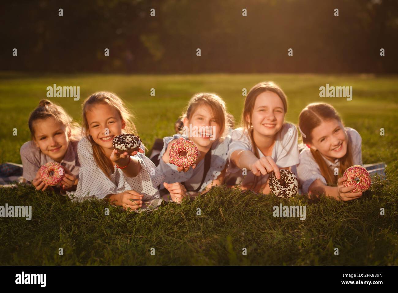 celebration of World Children's Day. Happy girls laying on green grass ...