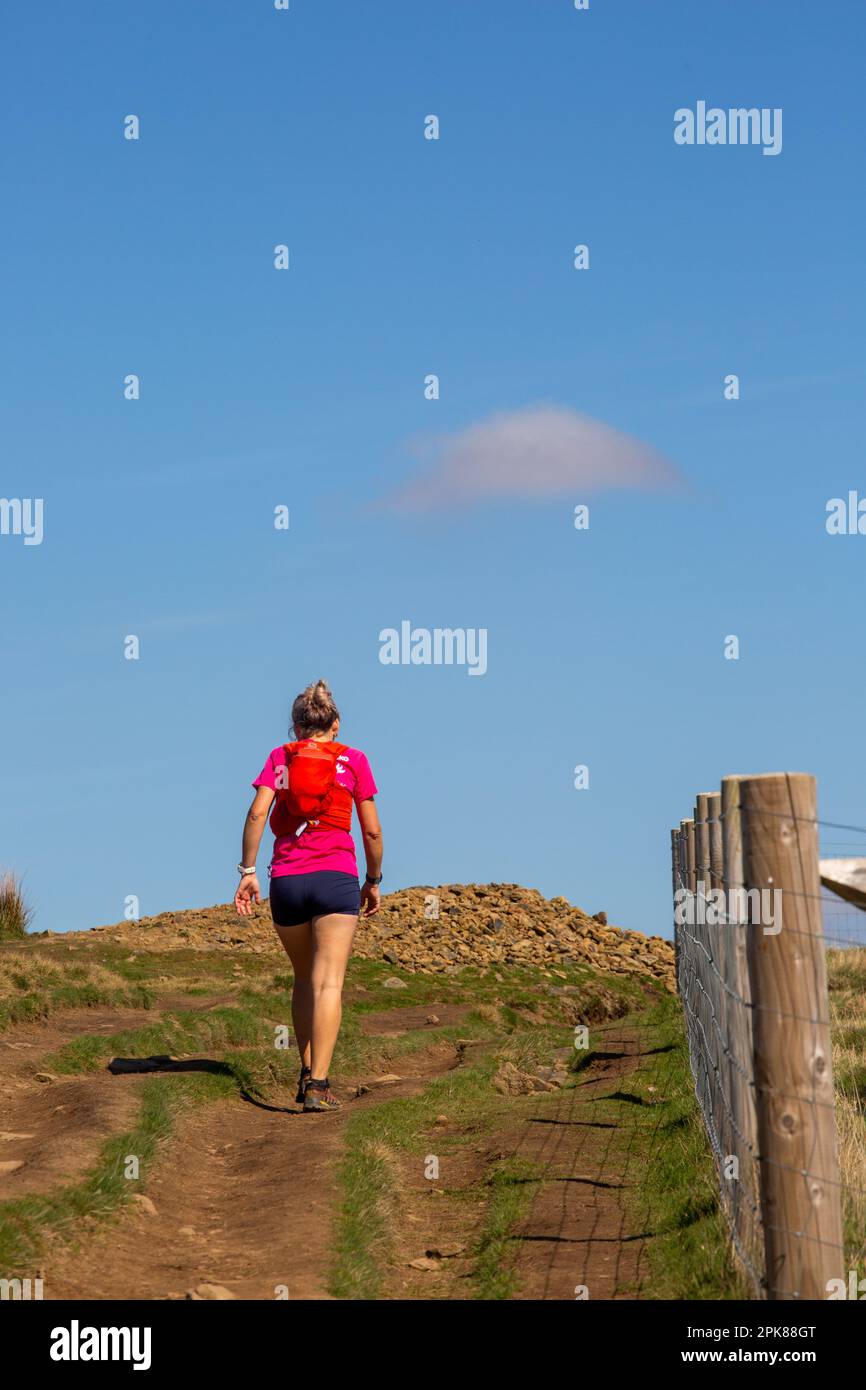 Woman walking the Great ridge from Mam Tor to Lose Hill high above ...