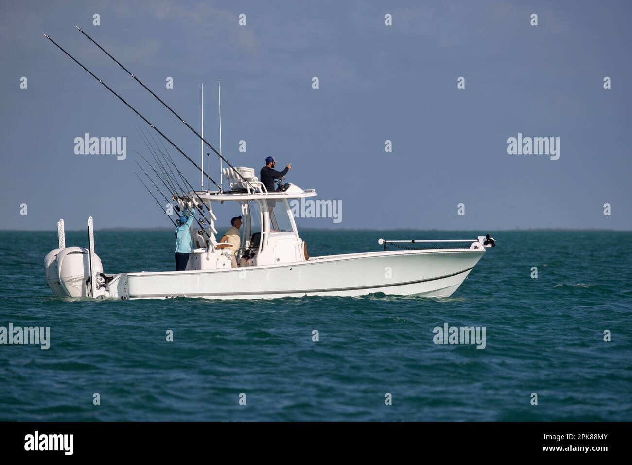 A center console fishing boat in the ocean with the driver gesturing ...