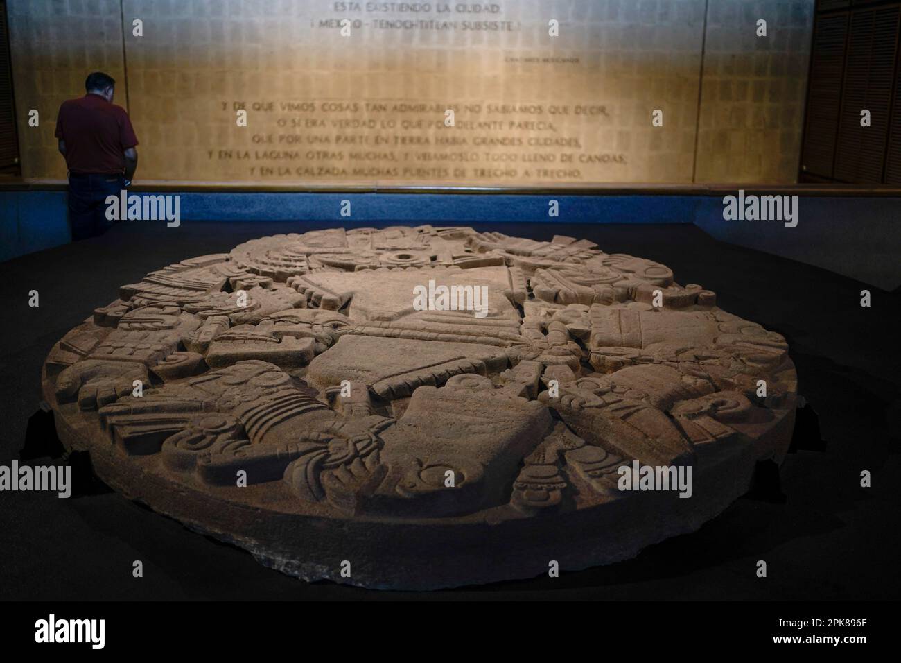 A visitor reads information displayed on a wall while standing next to ...