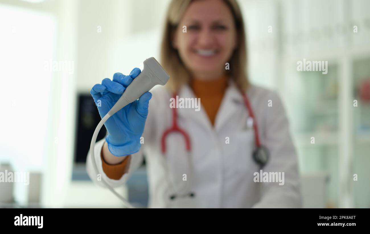 Doctor of ultrasound diagnostics holding probe in hands in clinic ...