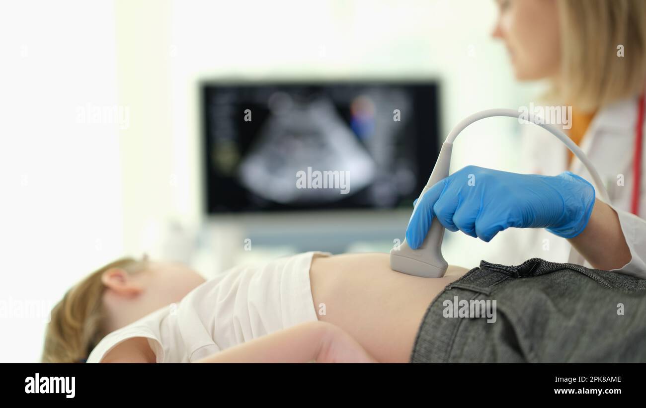Doctor gastroenterologist making ultrasound examination of liver and ...