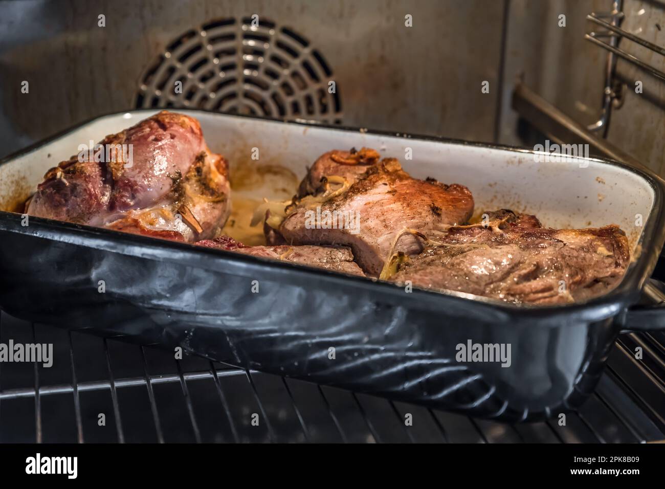 Real hearty homemade roast pork in a roaster casserole in the oven ...