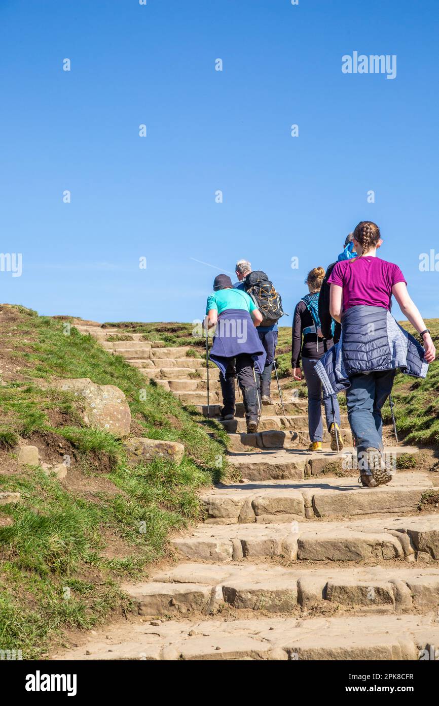 People climbing the steps up to the summit of Mam Tor the highest point ...