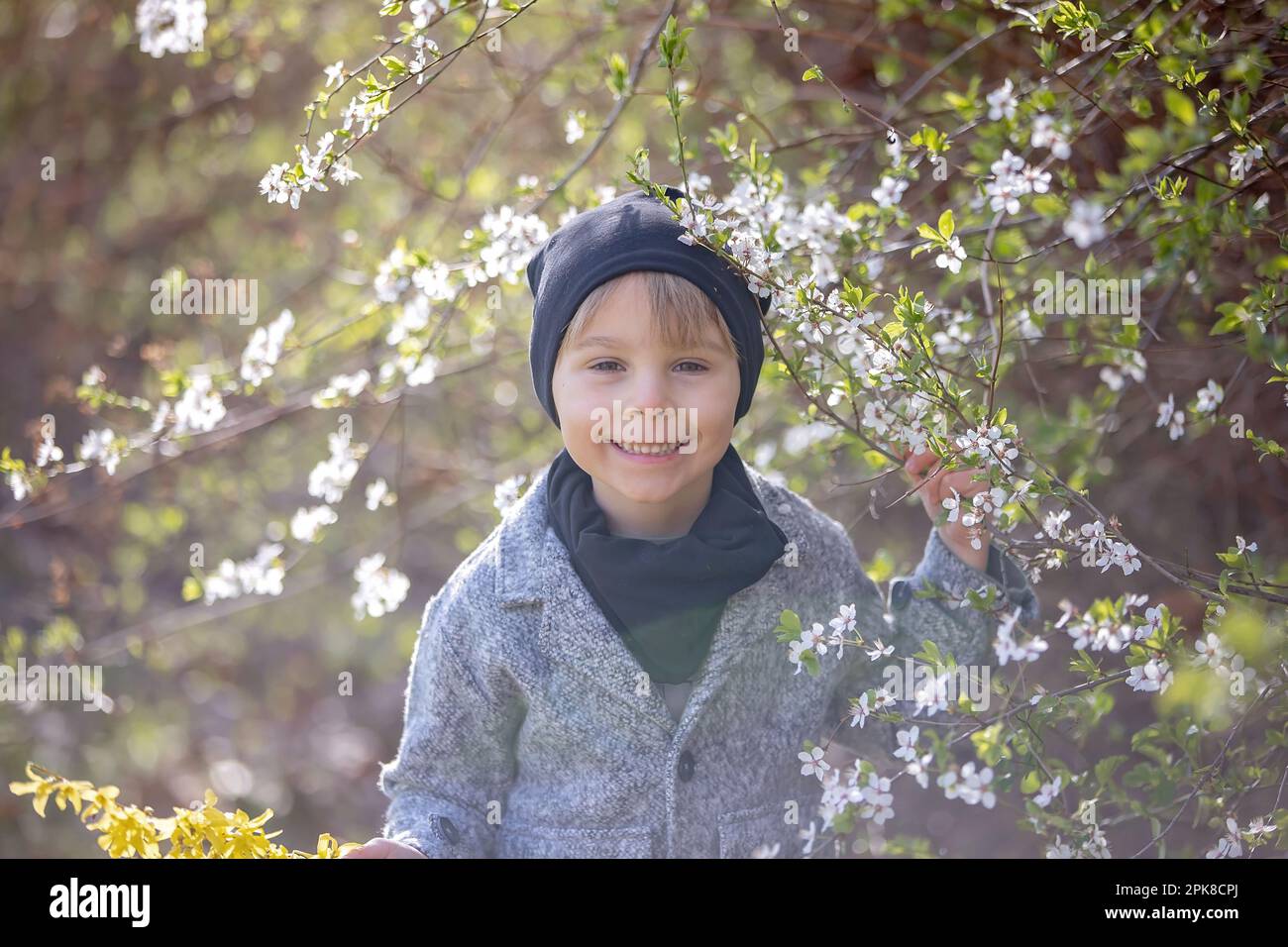 Cute preschool child, boy, holding handmade braided whip made from ...