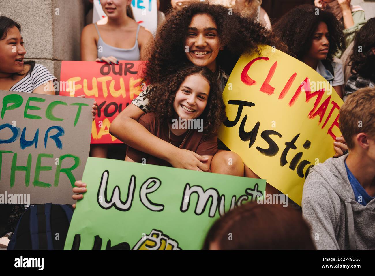 Sitting smiling holding crowd hi-res stock photography and images - Alamy