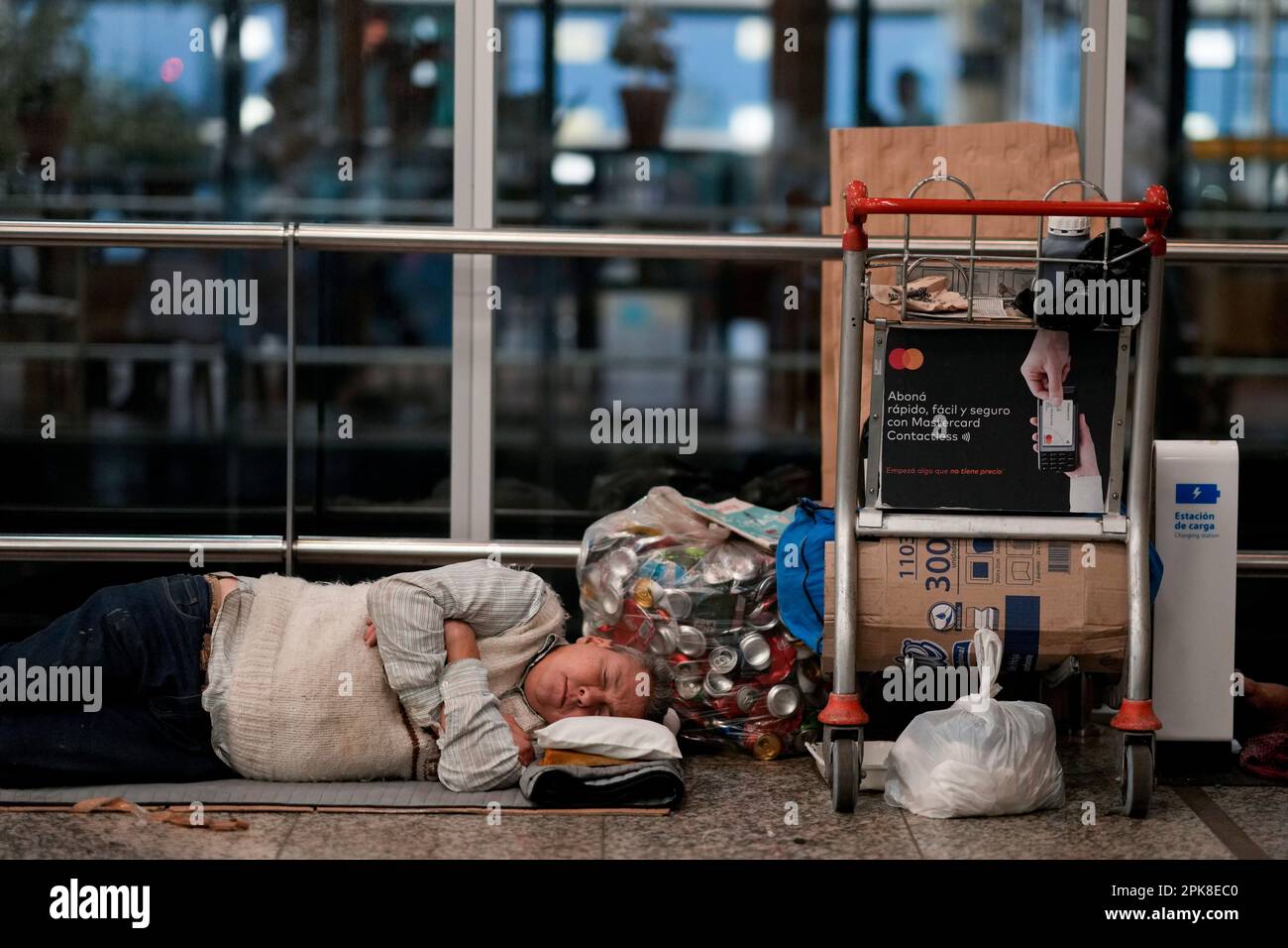 A homeless man sleep near his belongings at the Jorge Newbery ...