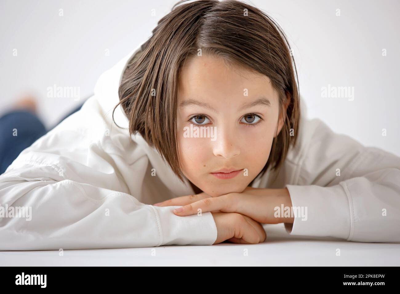 Cute stylish toddler child and older brother, boys with white shirts on ...