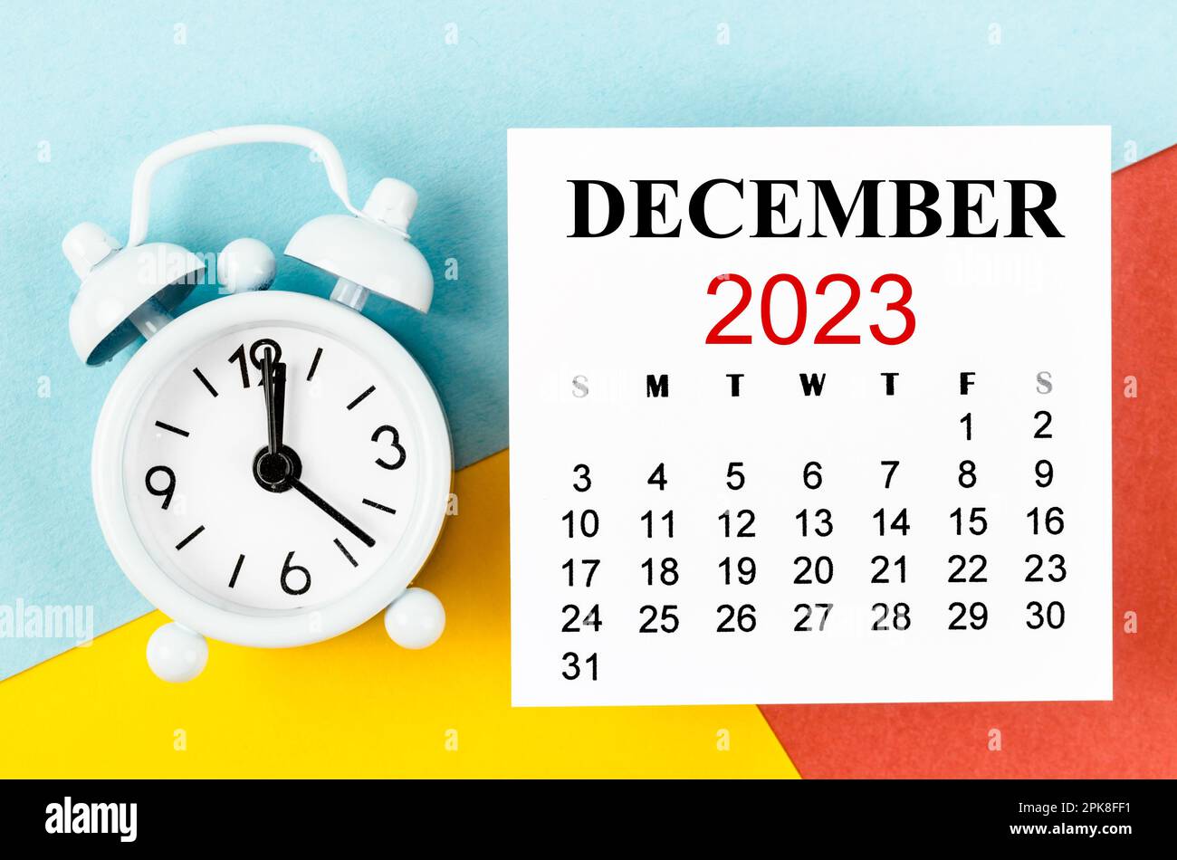 December 2023 Monthly calendar year with alarm clock on colourful ...