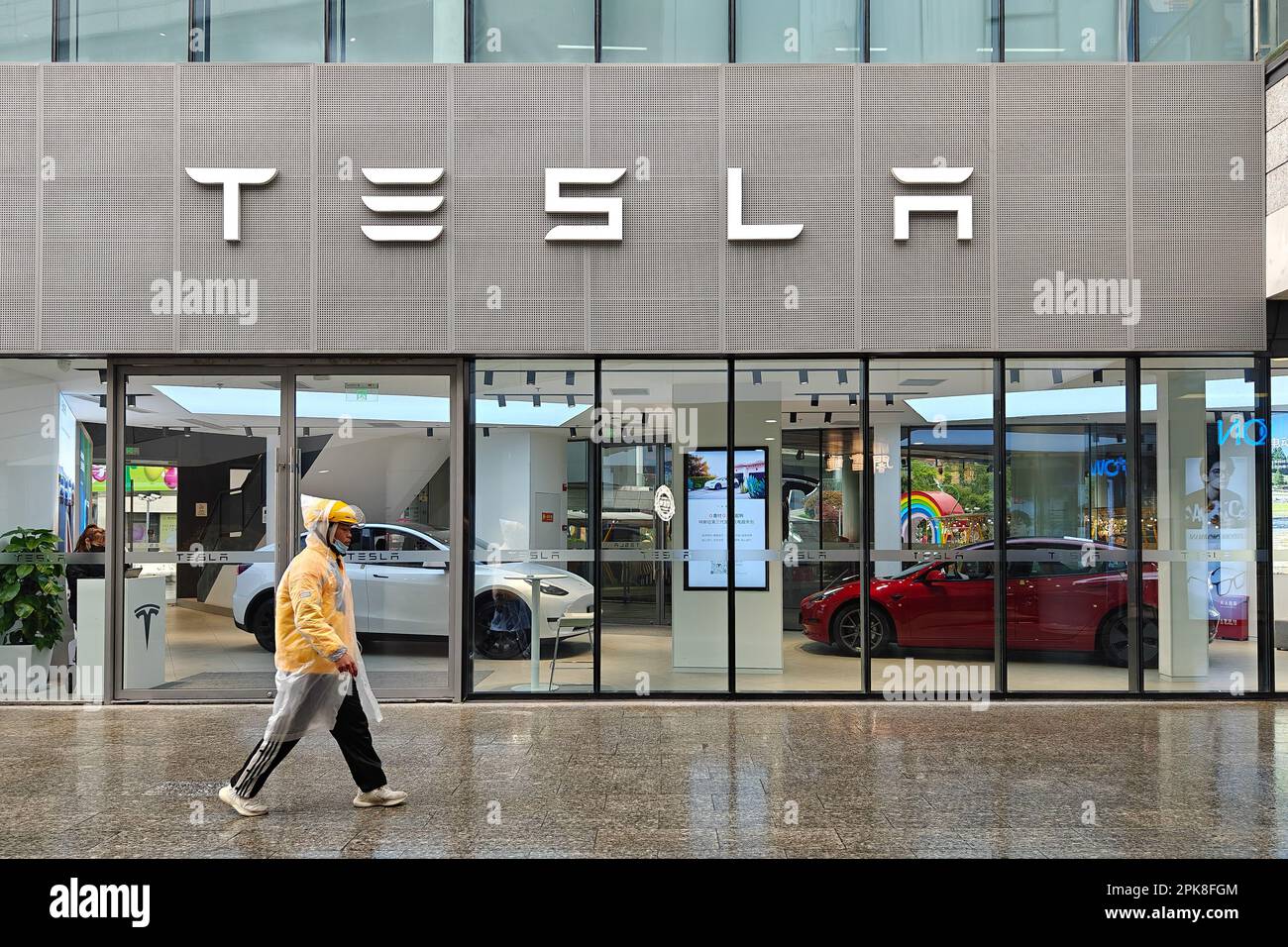 Shanghai China April 6 2023 Pedestrians Walk Past A Tesla