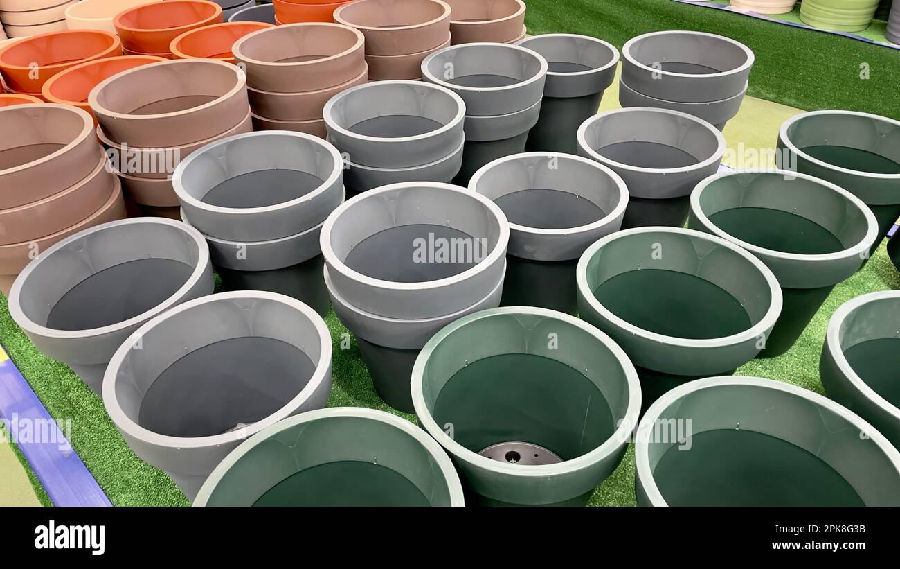 Close-up of empty flower pots in a store or greenhouse. Colorful pots ...