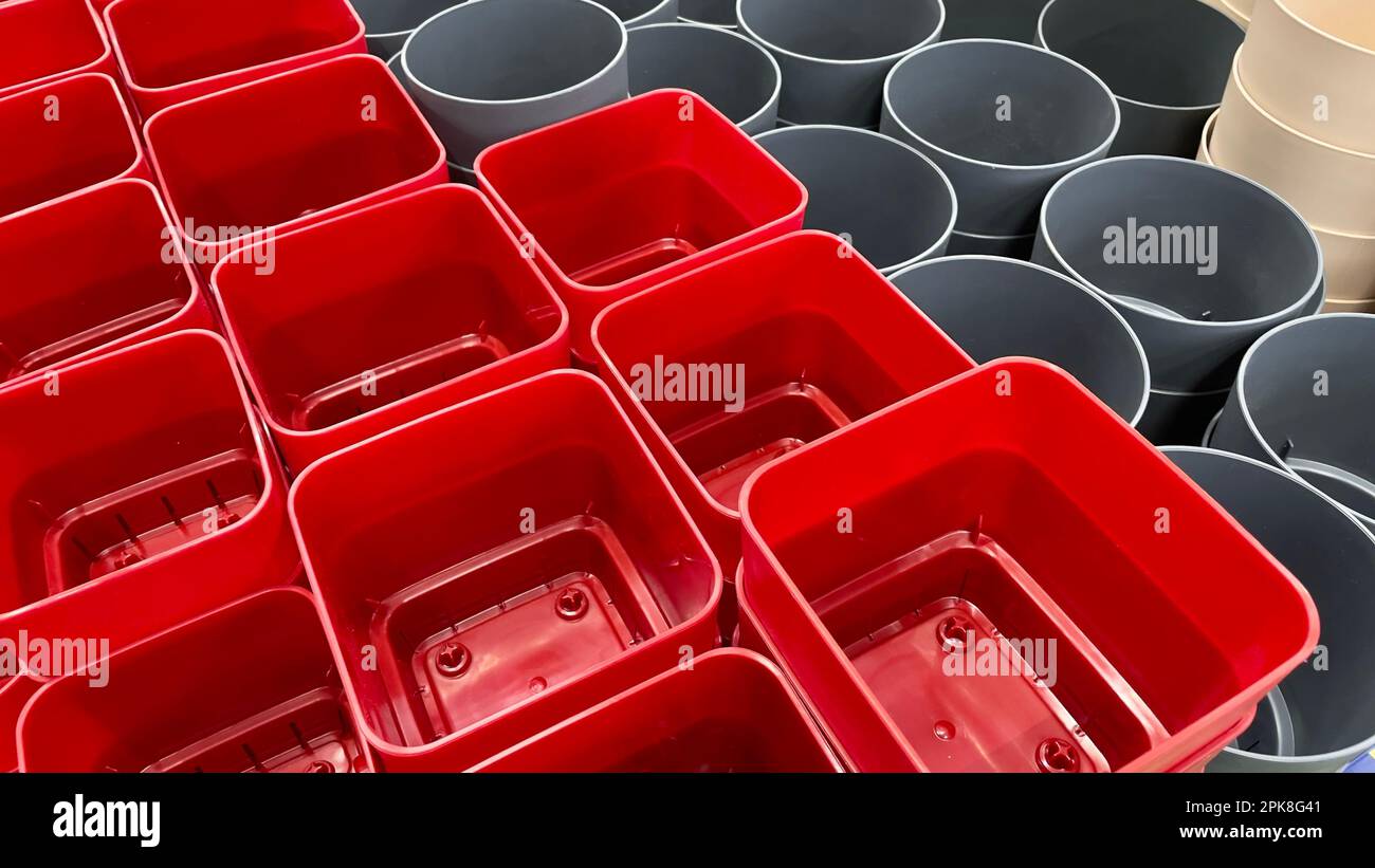 Close-up of empty flower pots in a store or greenhouse. Colorful pots ...