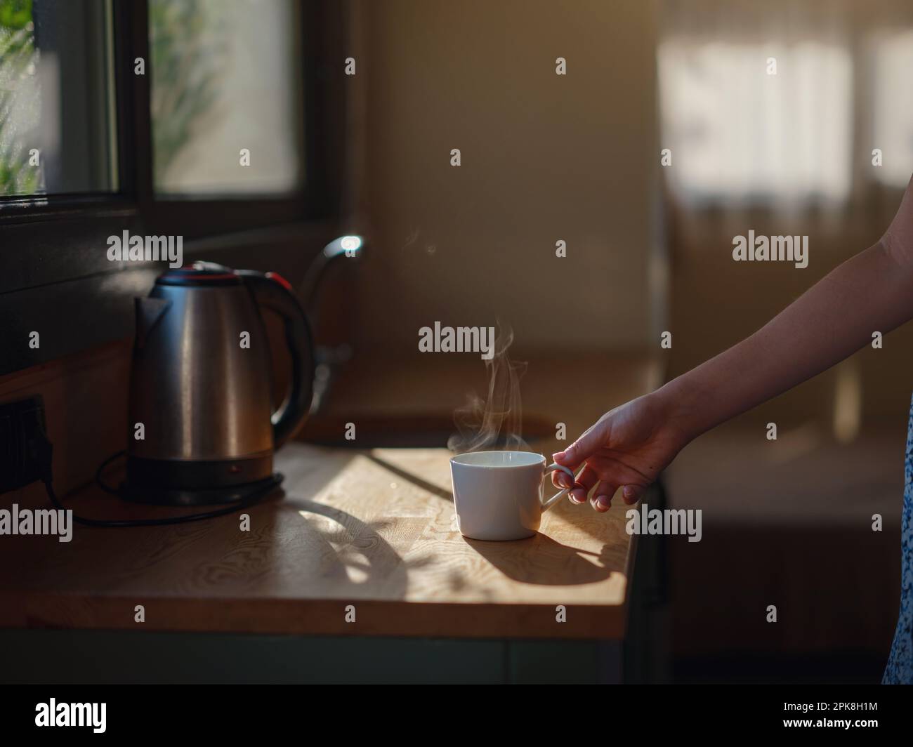 Woman is drinking coffee , morning routine. Tiny house. First property ...