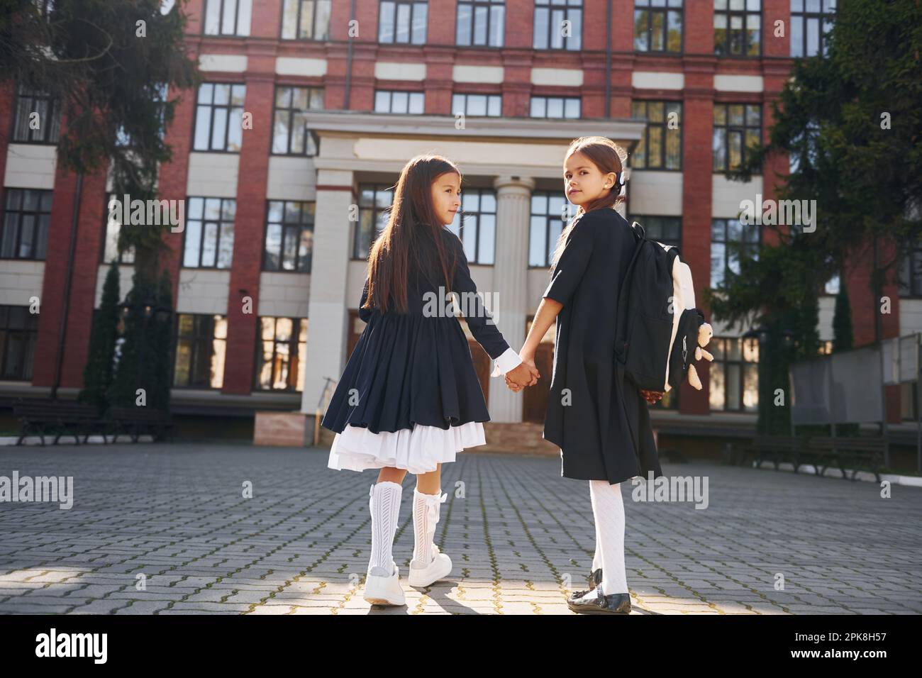 Rear view schoolgirls walking school hi-res stock photography and ...