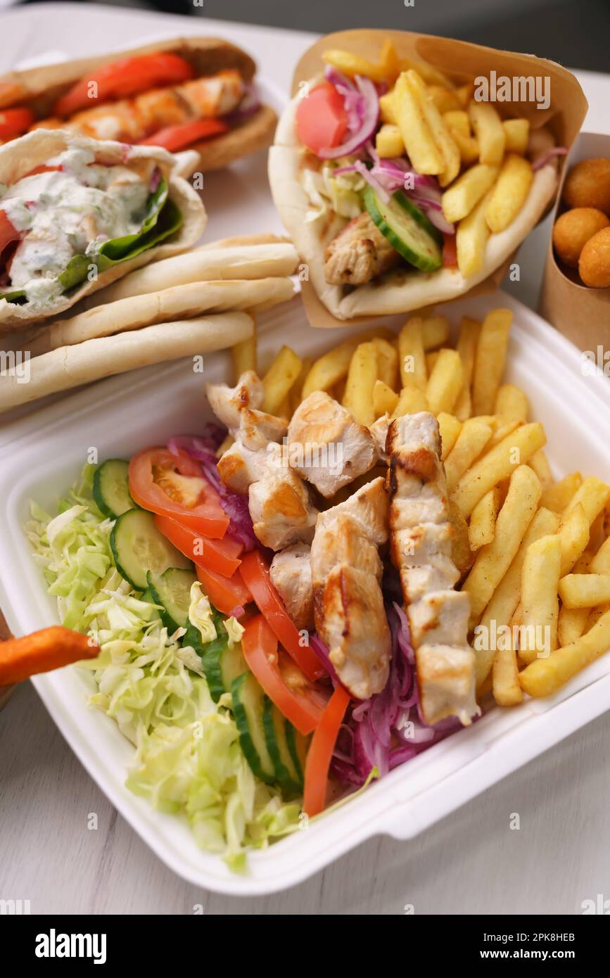 Greek kalamaki and pita gyros with grilled meat served for take away in ...