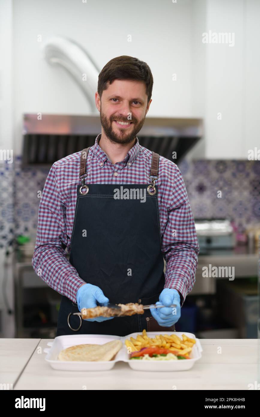 Cheerful white man working in a fast food restaurant. Portrait of ...