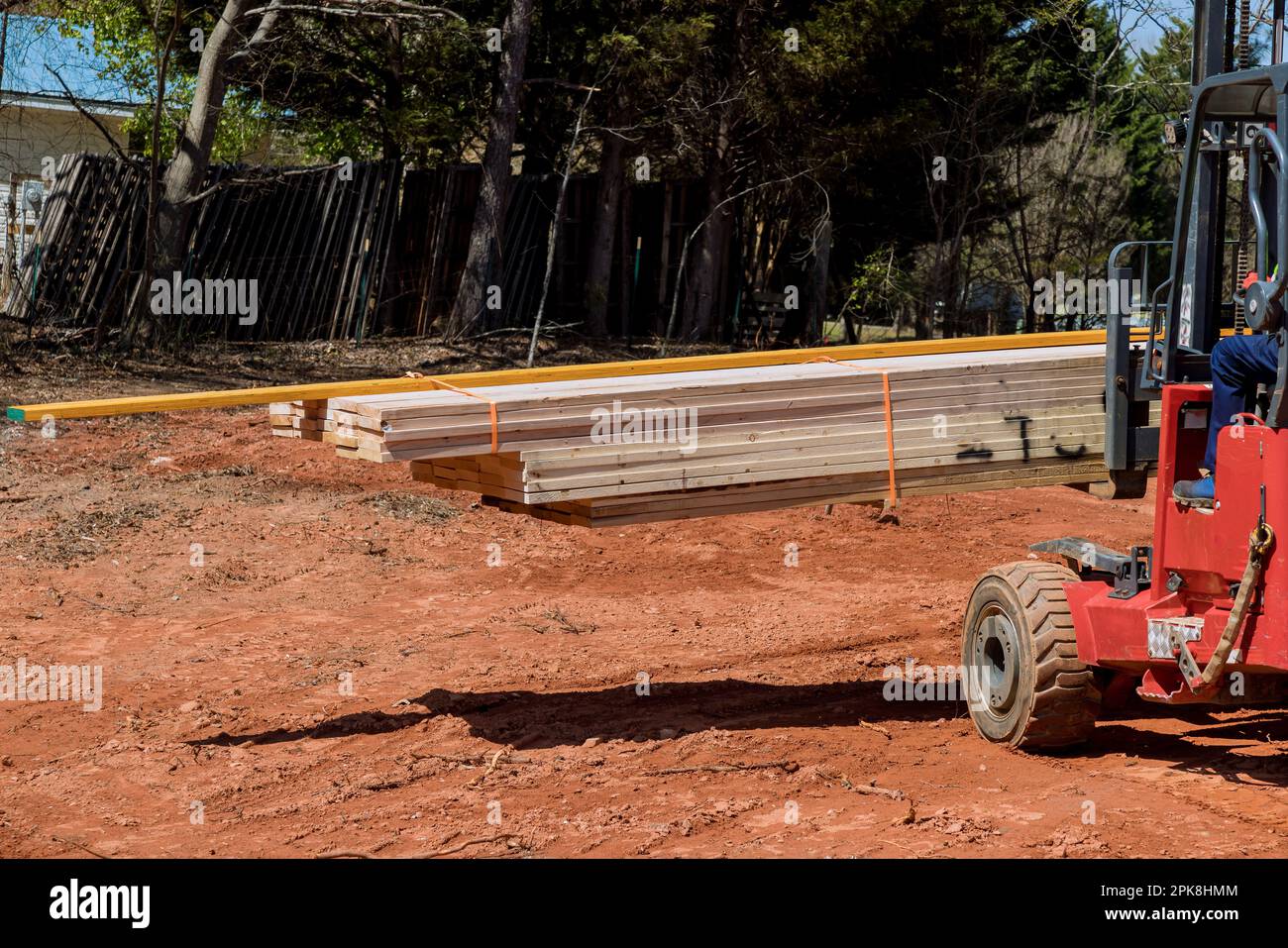 Using lift manipulator construction site worker unloads delivery of ...