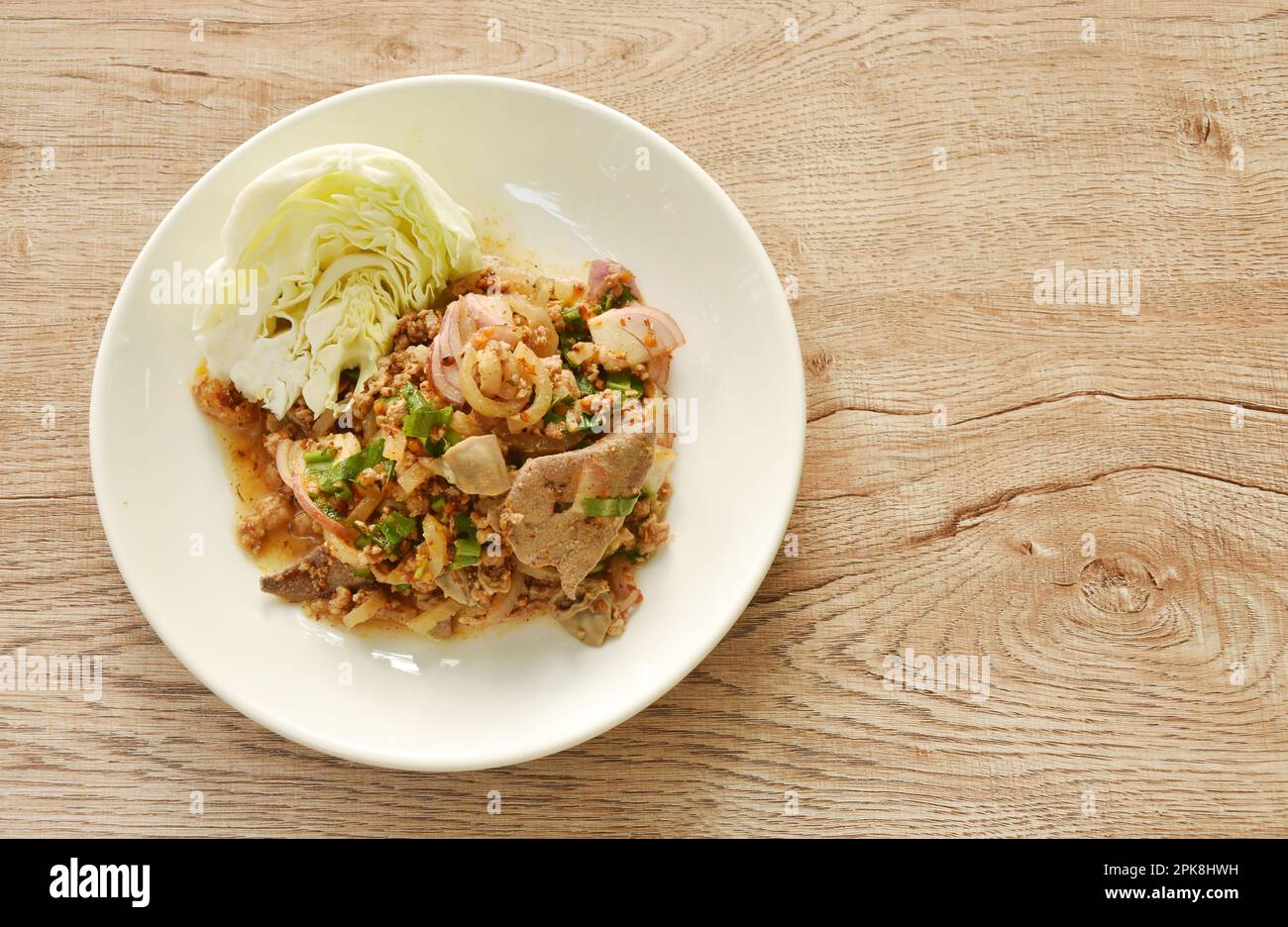 Thai spicy chop pork and slice skin salad with fresh vegetable on plate ...