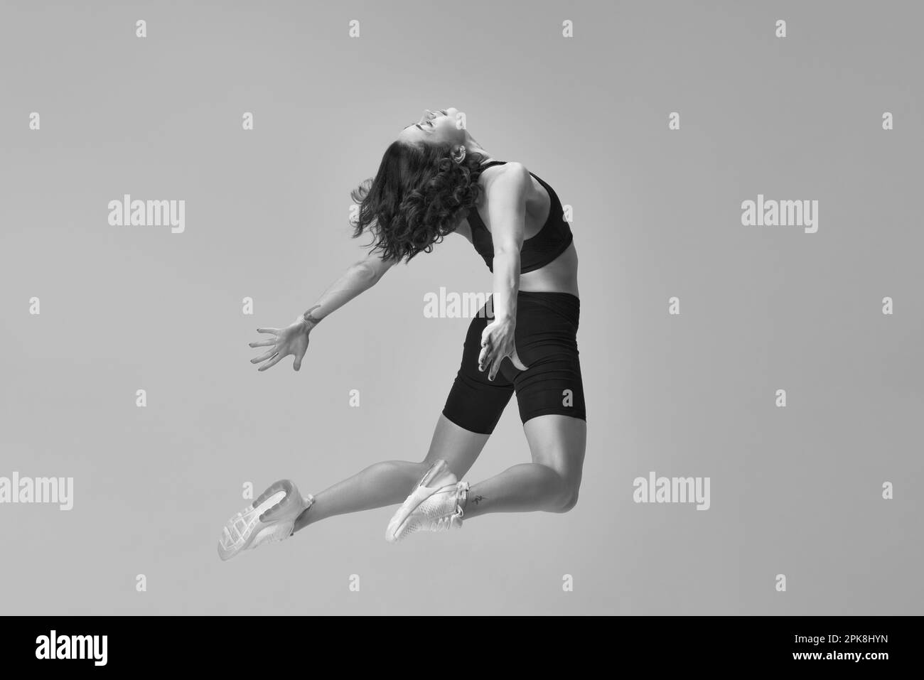 Black and white image. Freedom. Young athletic, slim woman in ...