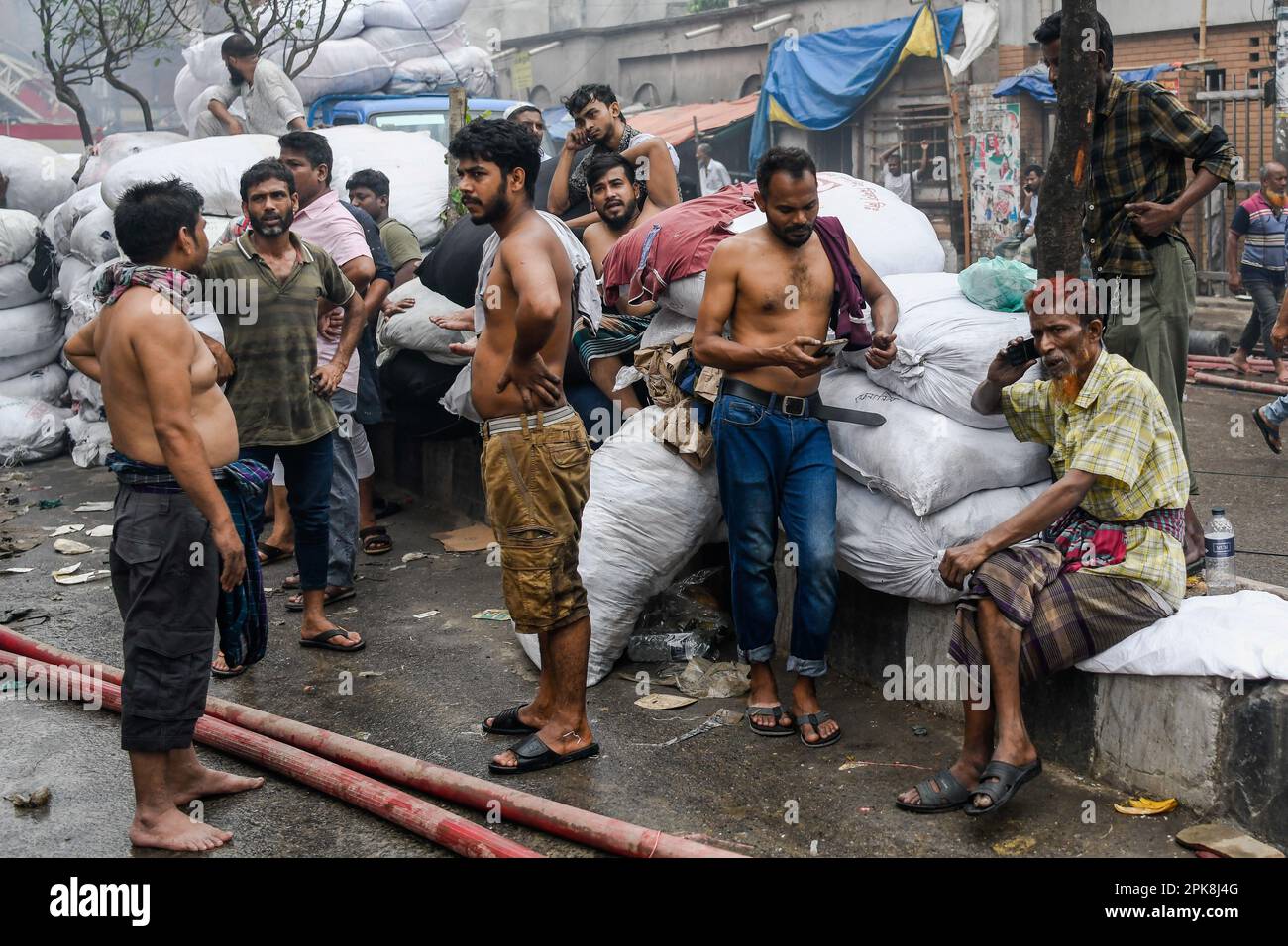Traders pack up and move clothes rescued from Anexco Tower in the ...