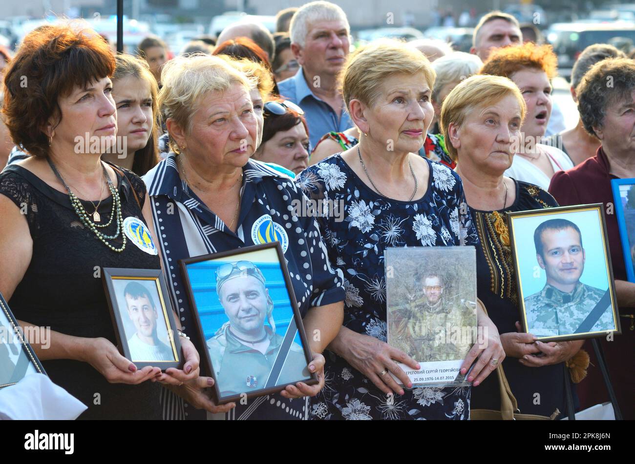 Mourning women mothers and wives crying and holding a portraits of ...