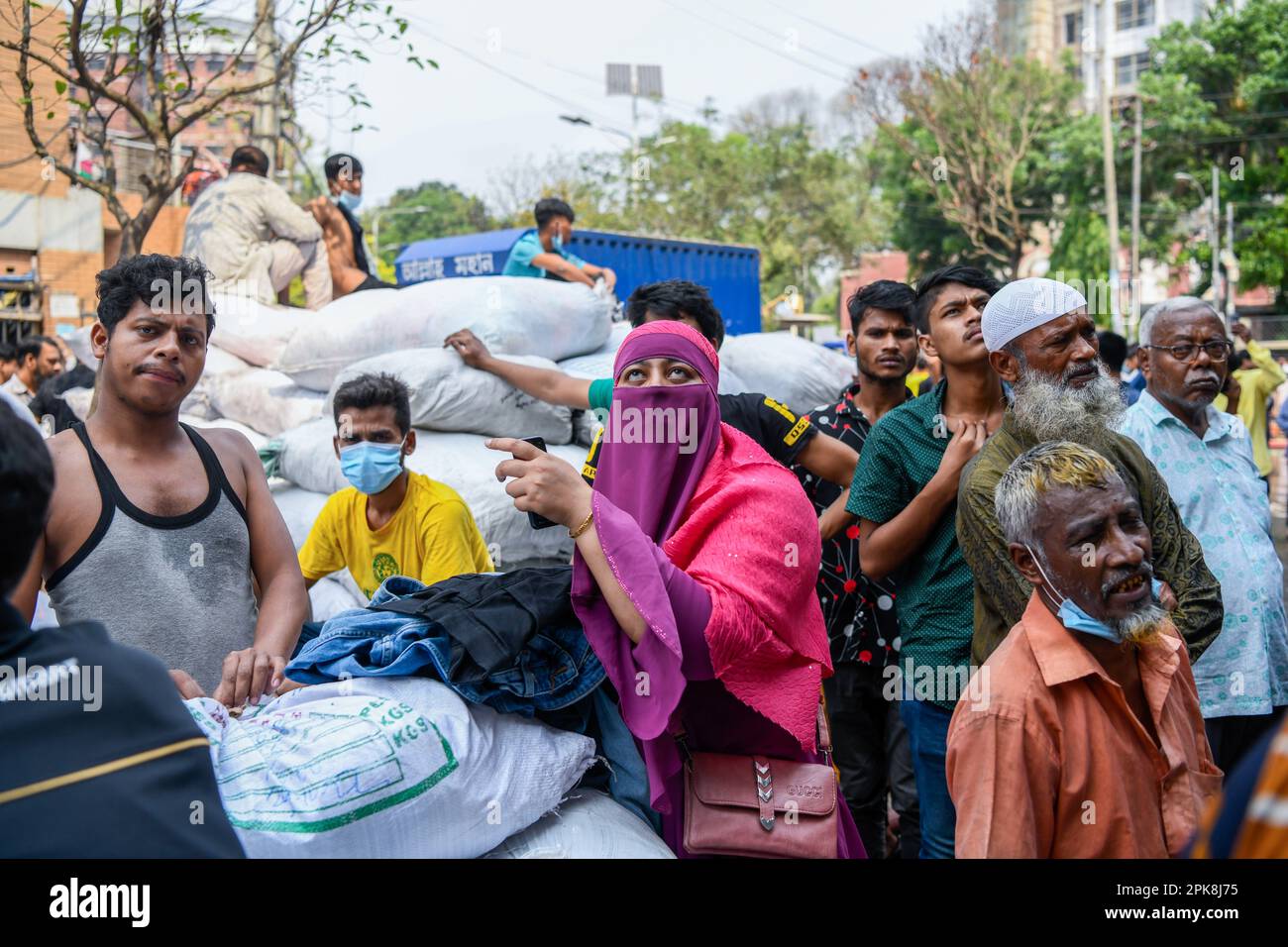 Traders pack up and move clothes rescued from Anexco Tower in the ...