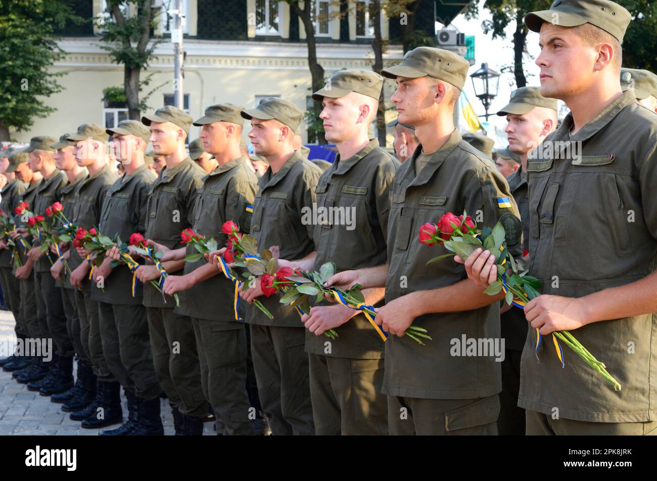 Ukrainian soldiers in military uniform standing in a rank and holding ...
