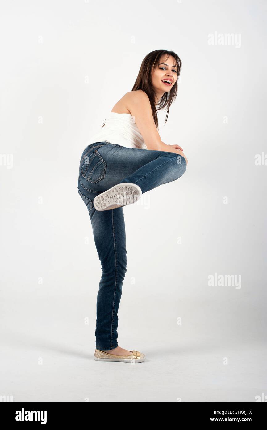 Young woman dancing breakdance in the studio on white background. in a ...